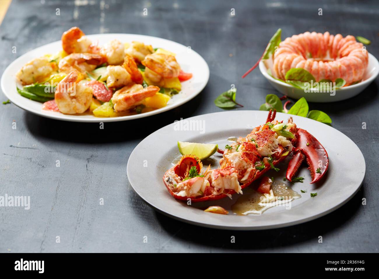 Three crustacean dishes: prawns with fruit, a ring of prawns and ...