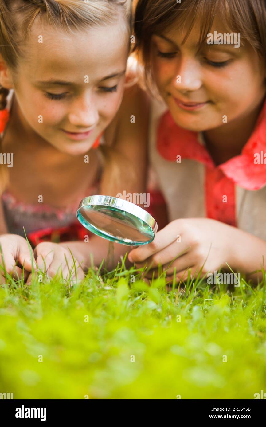 Kid with magnifying glass Stock Photo - Alamy
