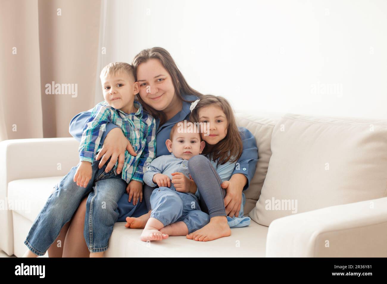 Mother and three children Stock Photo - Alamy