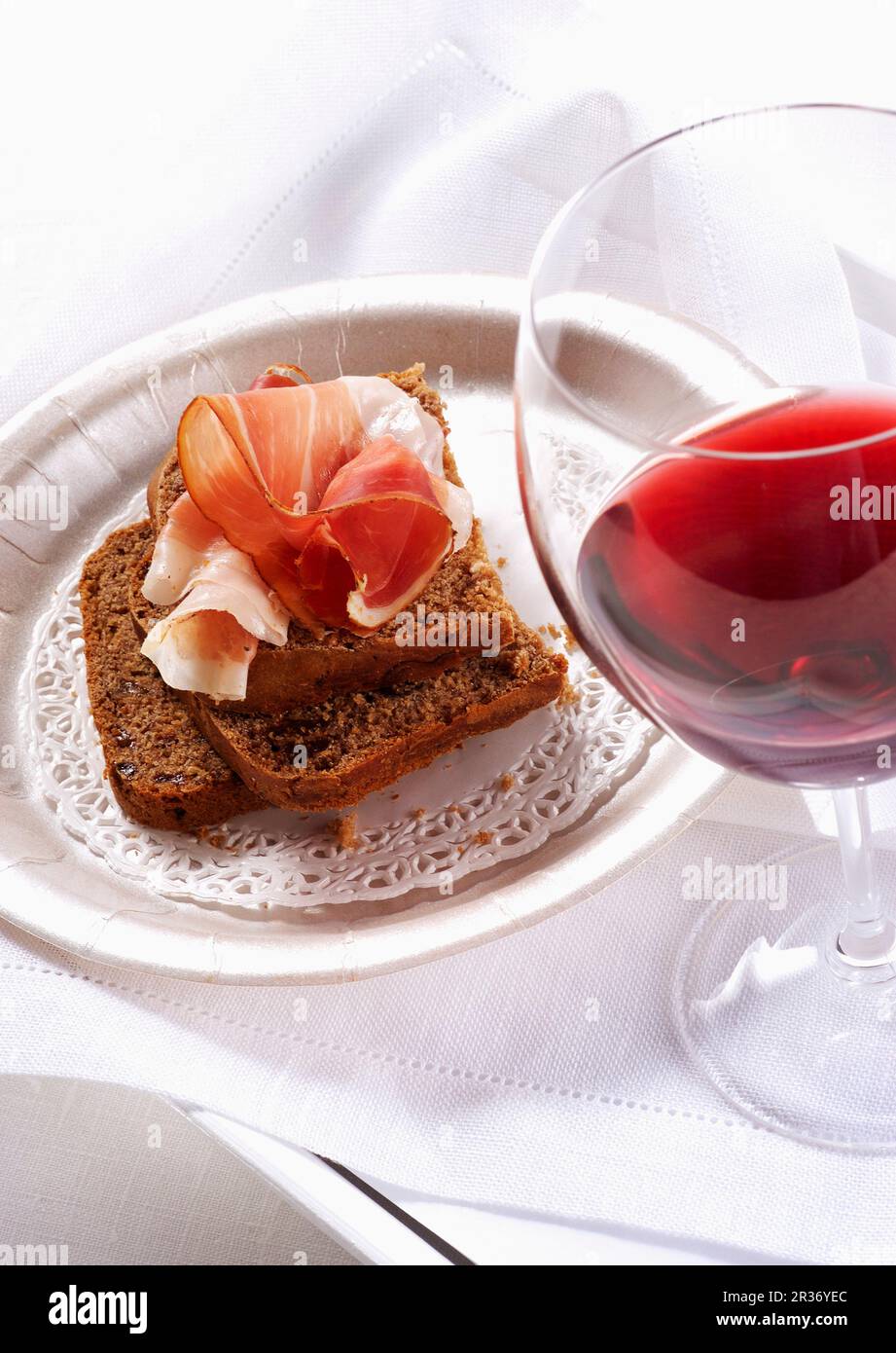 Chestnut bread with cured ham and a glass of red wine Stock Photo - Alamy