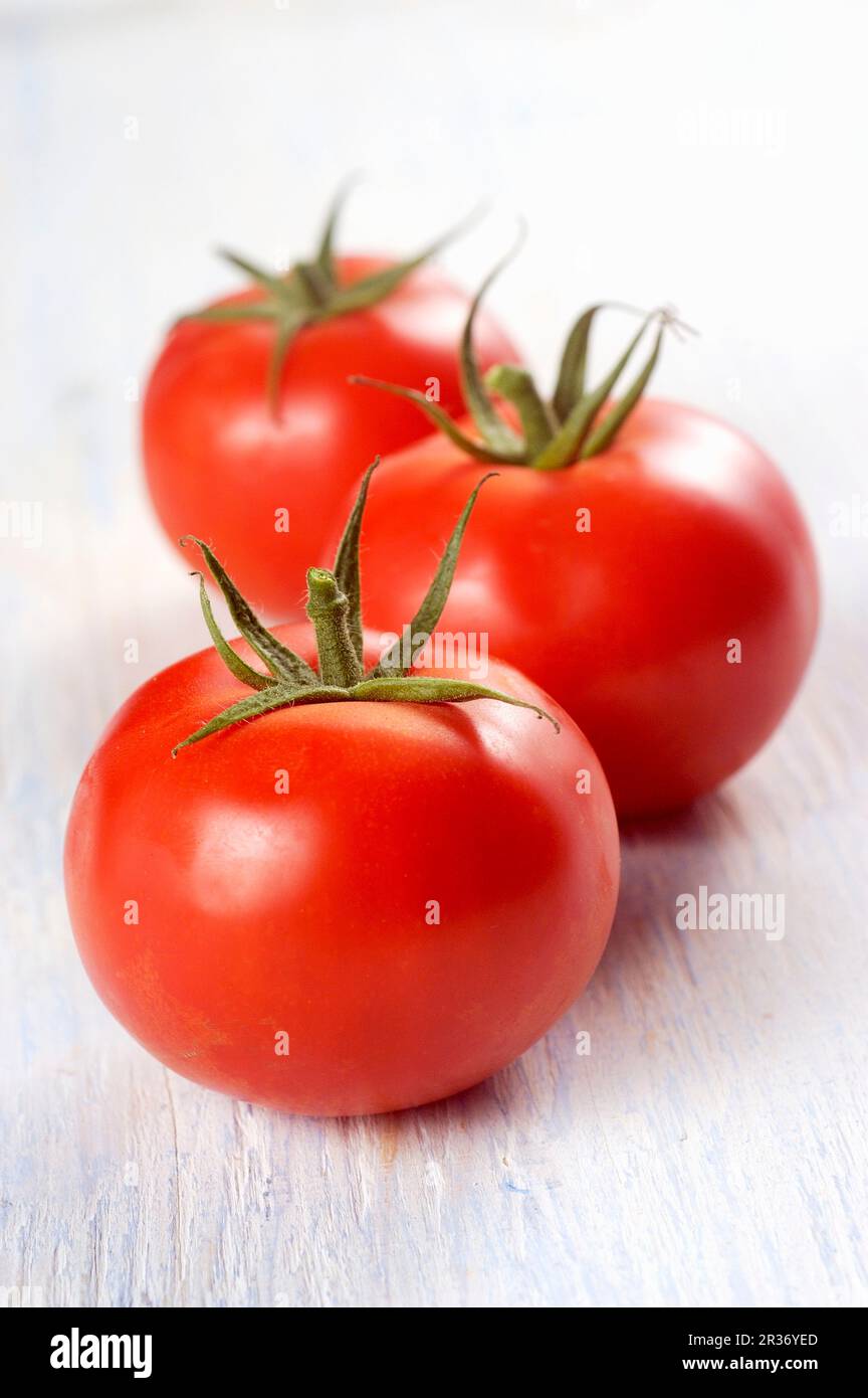 Three Vine Ripe Tomatoes on White Stock Photo - Alamy