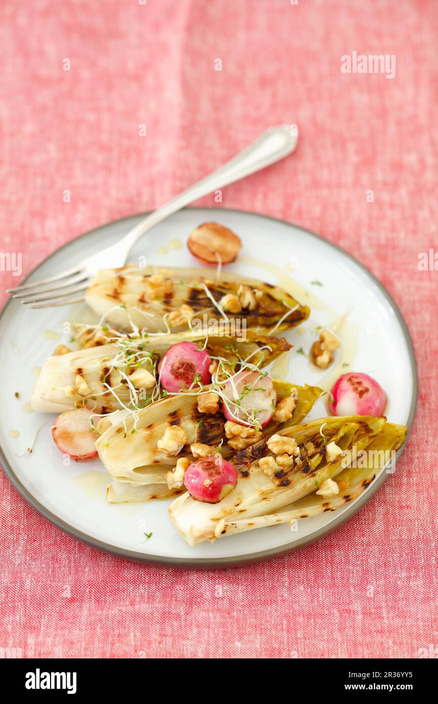 Grilled chicory and radishes with walnuts Stock Photo - Alamy