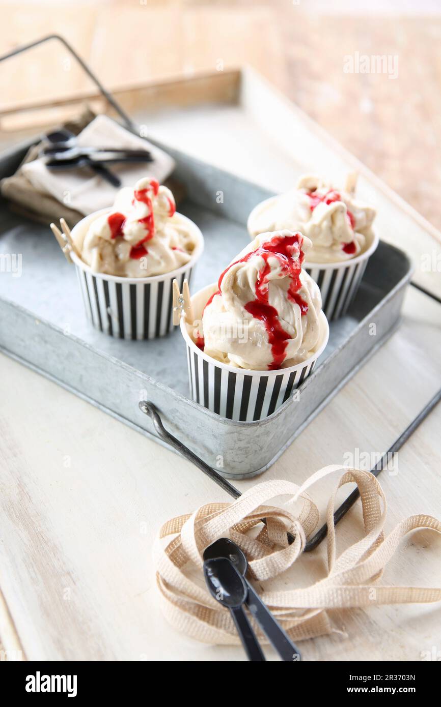 Raspberry ripple ice cream in paper cups on a metal tray Stock Photo ...