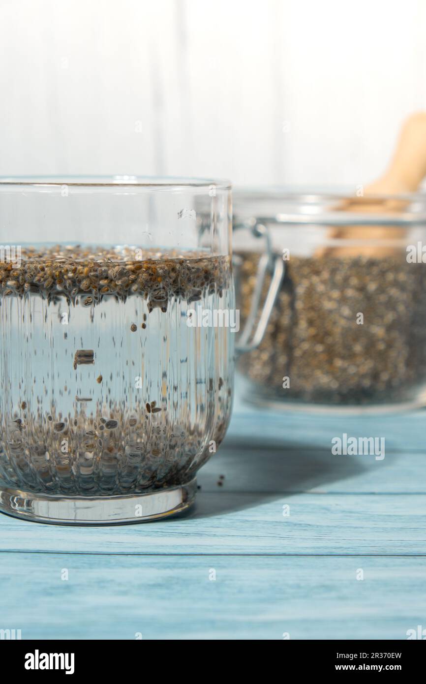 Preparing superfood water drink rich in Omega 3 fatty acids. Pouring ...