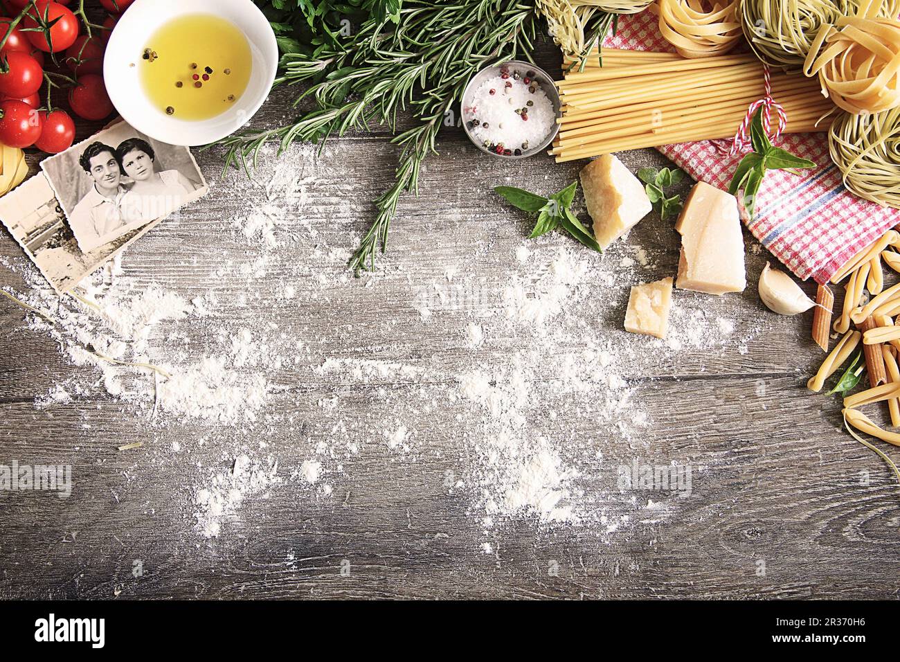 An arrangement of typical Italian food items and family photos on a ...