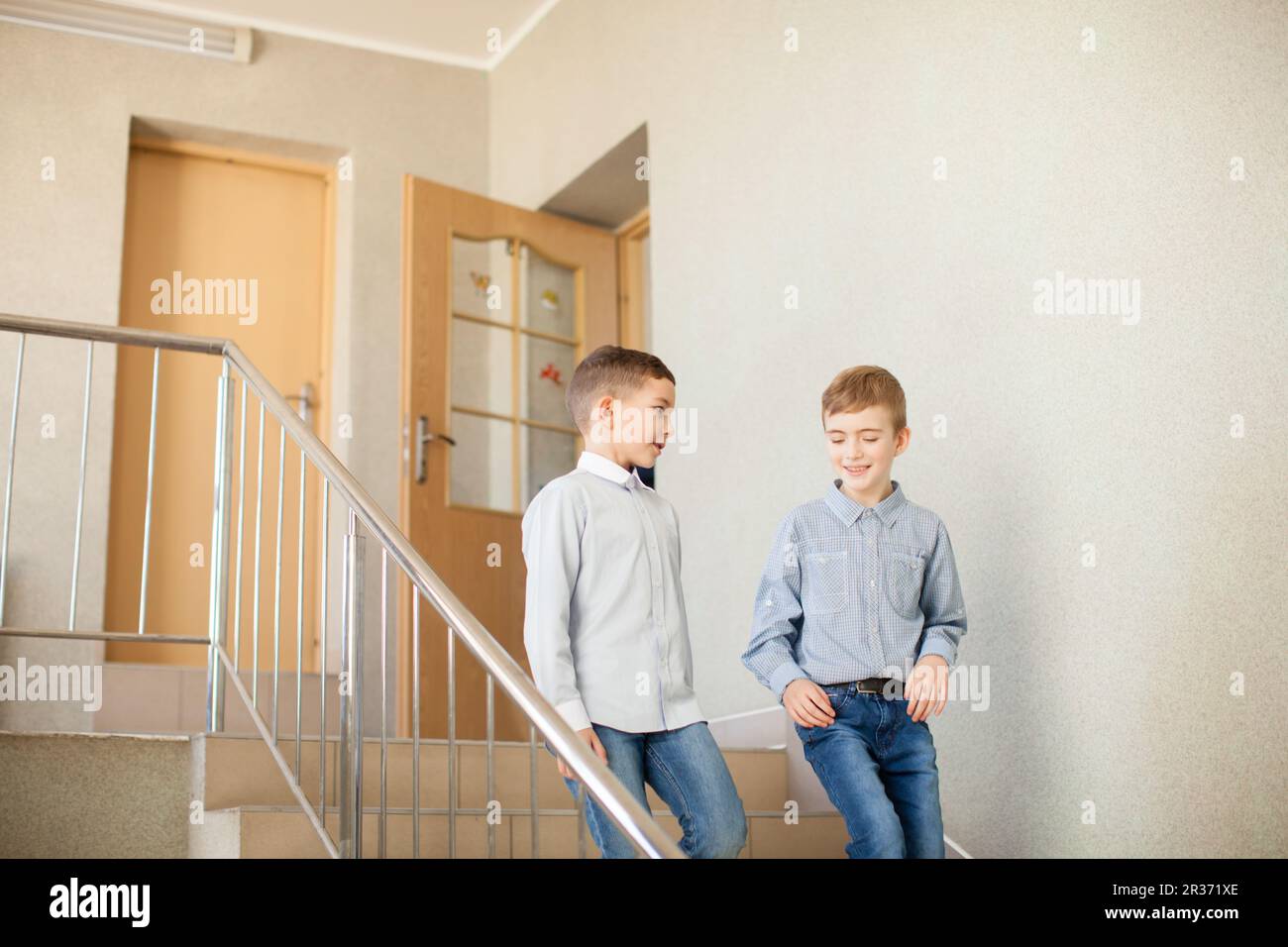 Two boys go downstairs Stock Photo - Alamy