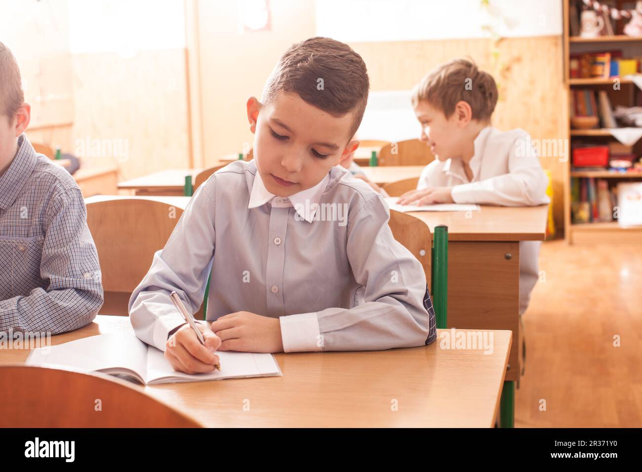 Boy white in the copybook Stock Photo - Alamy