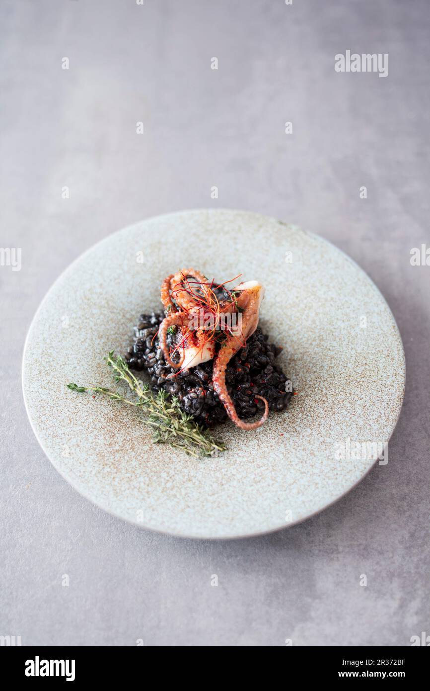 Black risotto with squid Stock Photo - Alamy