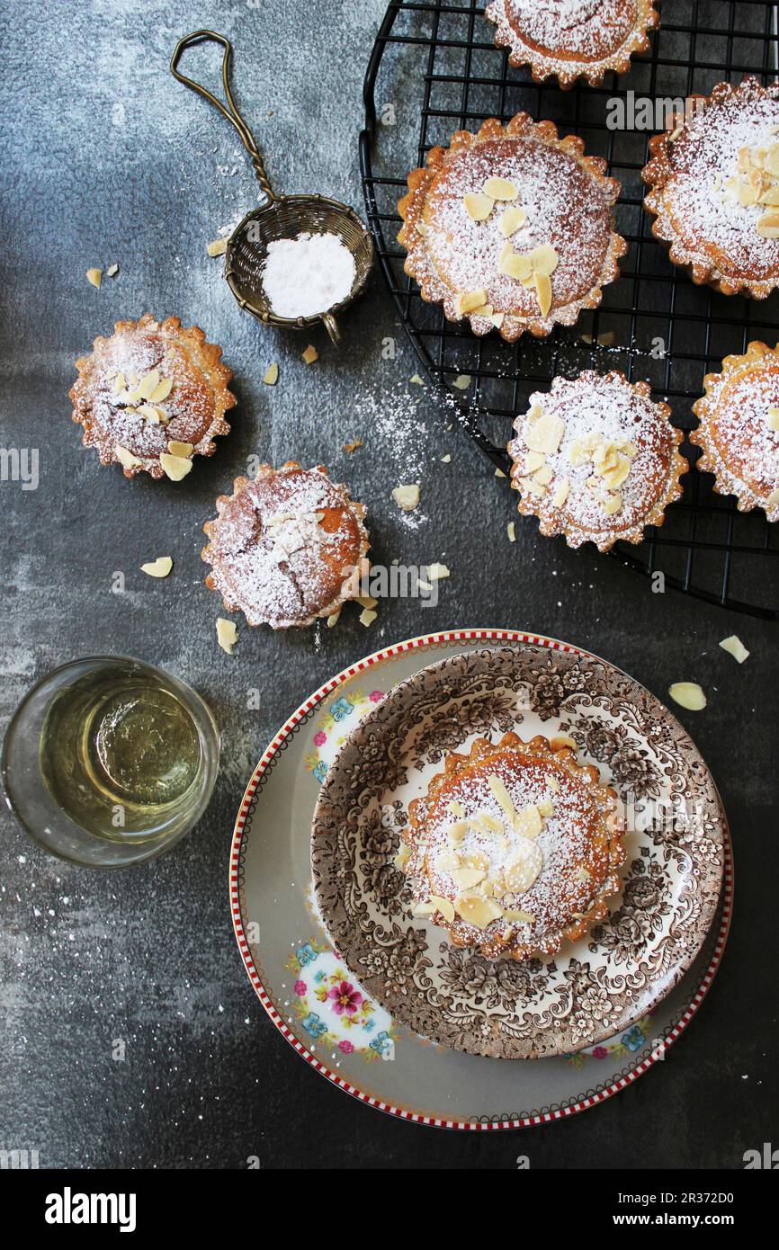Small almond cakes dusted with icing sugar Stock Photo - Alamy