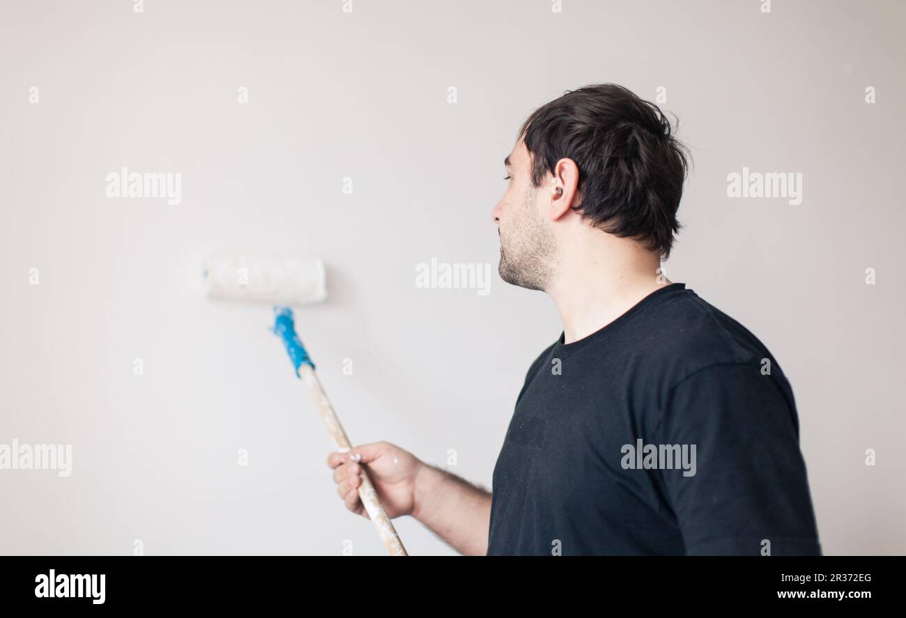 Man paints white wall hi-res stock photography and images - Alamy