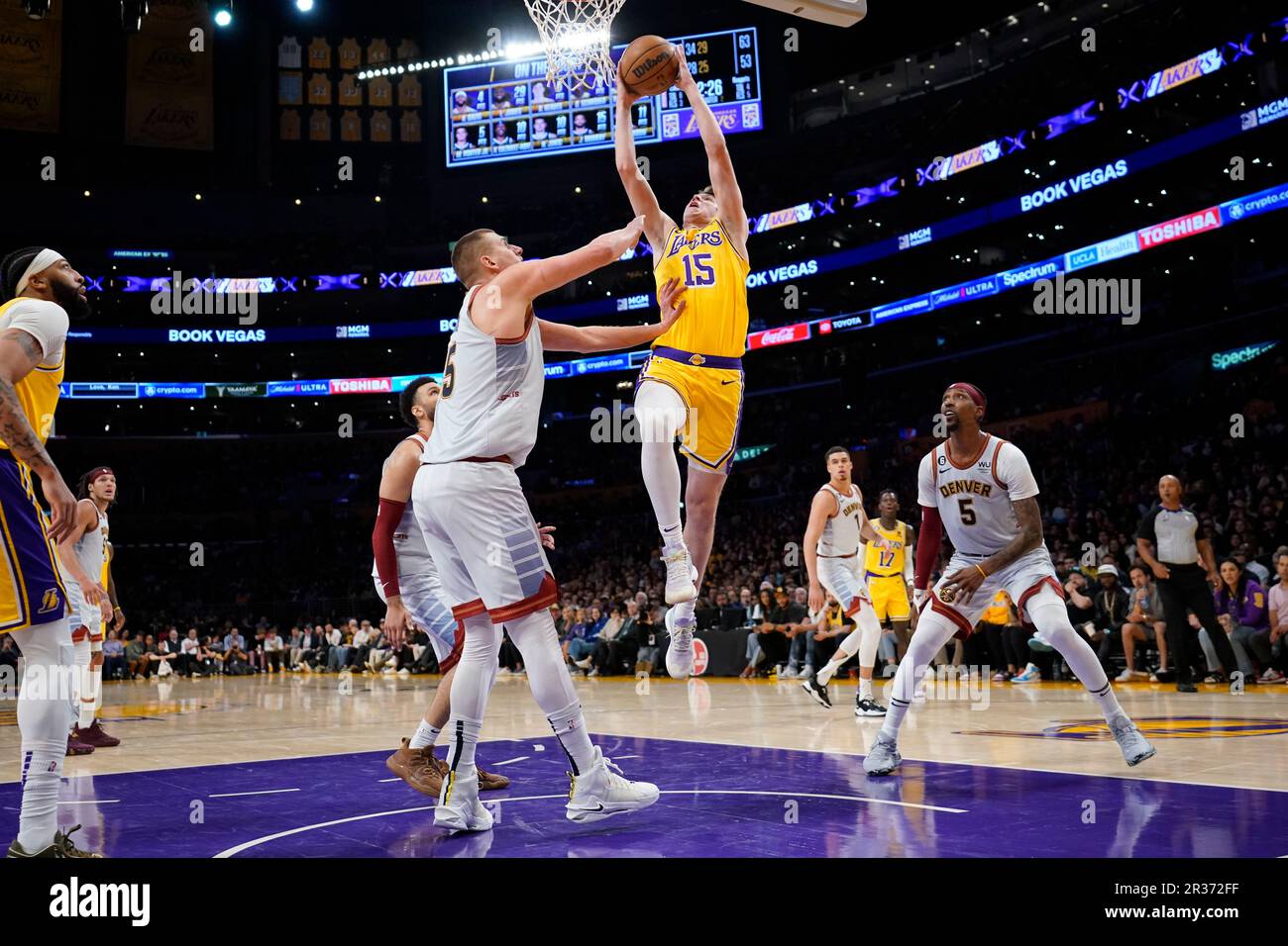 Los Angeles Lakers guard Austin Reaves (15) scores over Denver Nuggets center Nikola Jokic in ...