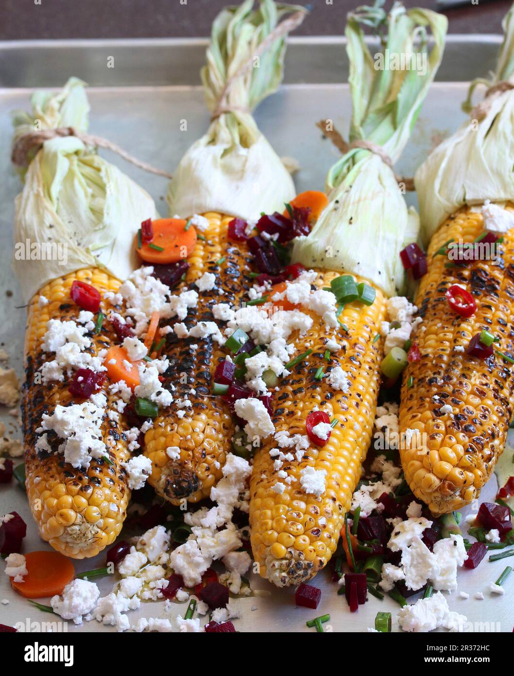 Grilled corn on the cob with vegetables and feta Stock Photo - Alamy