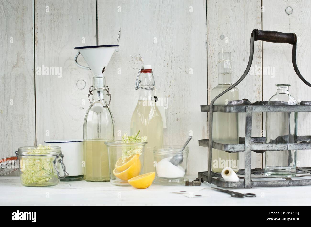 Homemade elderflower cordial in bottles, fresh elderflowers, lemon ...