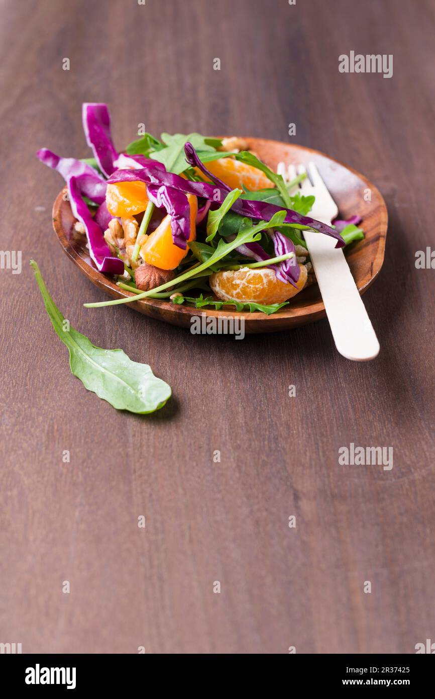 A rocket and red cabbage salad with nuts, wheat and tangerines Stock ...