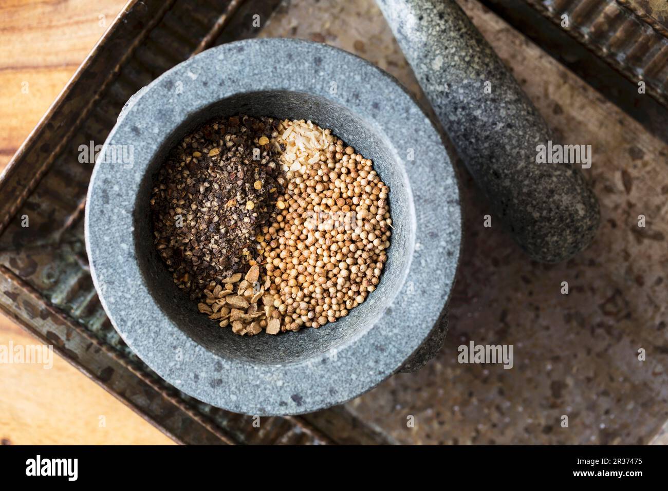 Pepper, ginger, coriander seeds and garlic in a mortar Stock Photo - Alamy