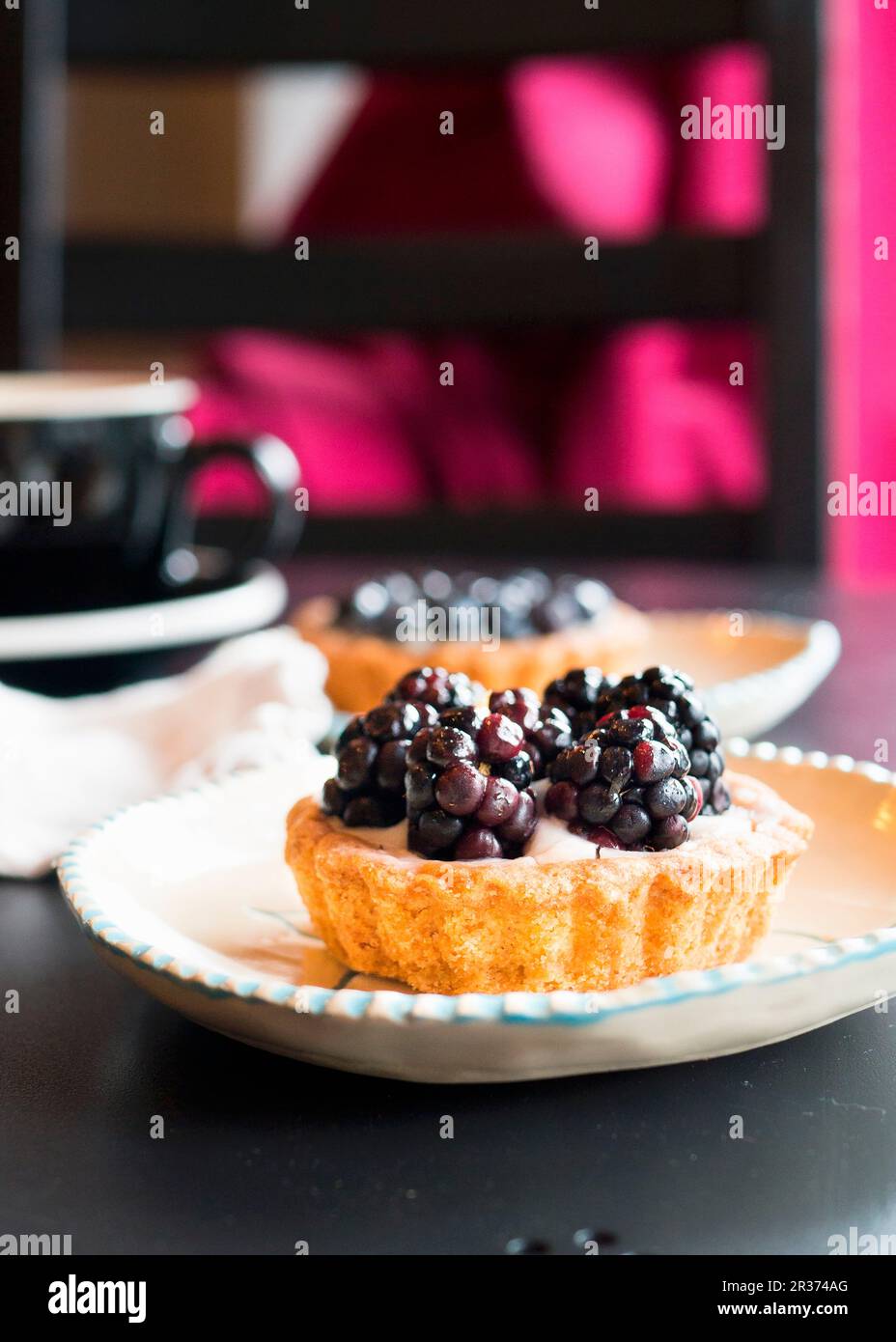 Berry tart dessert at a cafe Stock Photo - Alamy