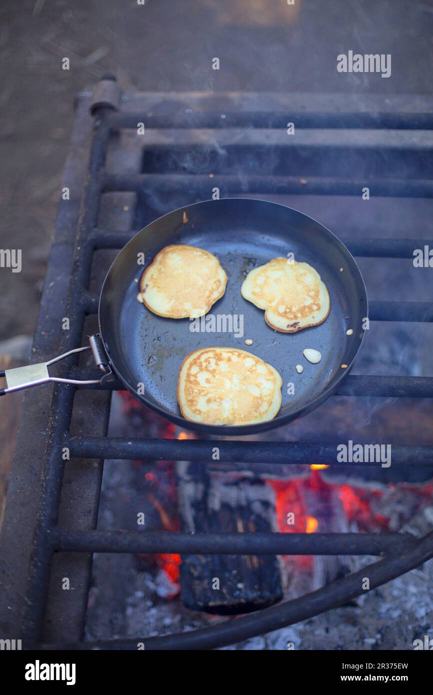 Pancakes in a pan on a fire grate Stock Photo - Alamy