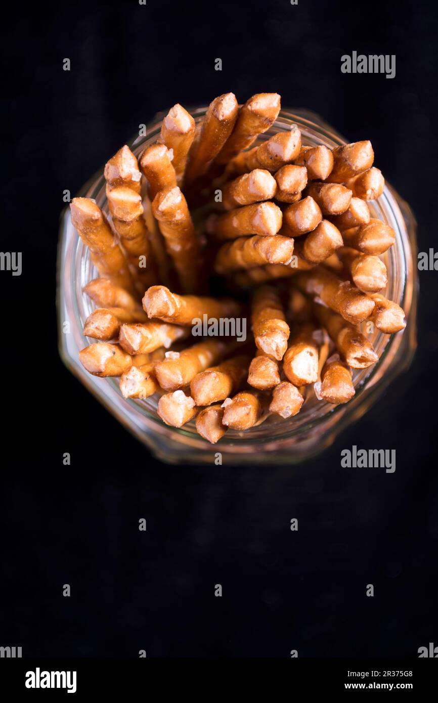 Pretzel stick in a jar on the black background Stock Photo - Alamy