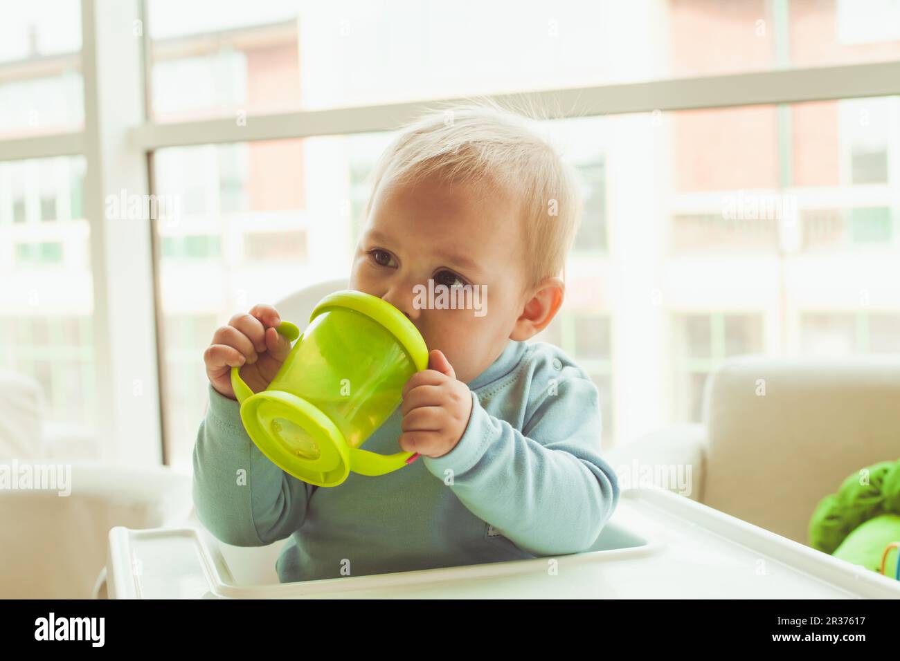 Little boy with baby cup Stock Photo - Alamy