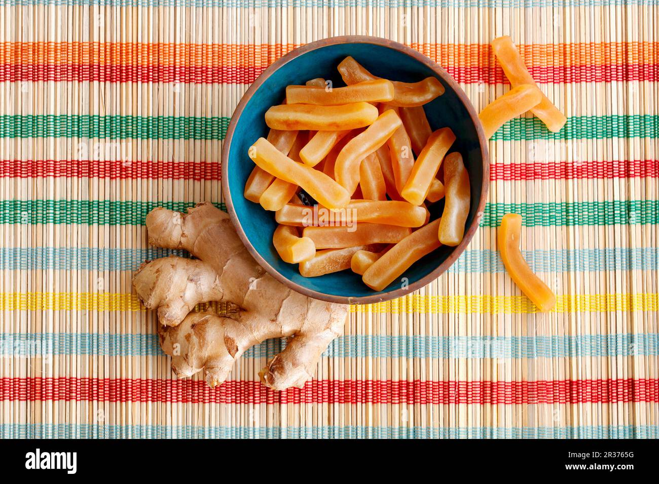 Ginger fruit gums and a fresh ginger root Stock Photo - Alamy