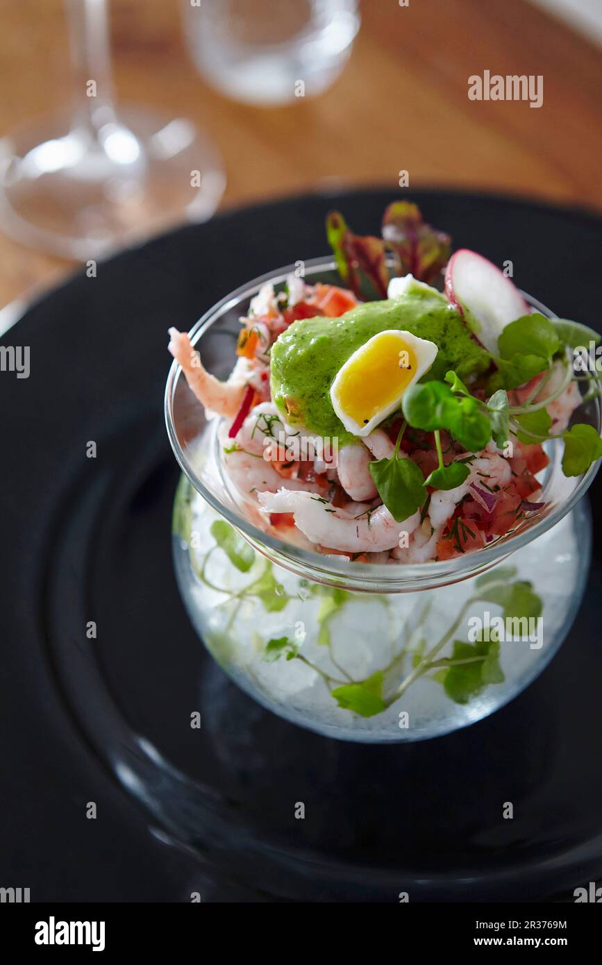 Shrimp salad with quail egg on ice Stock Photo - Alamy