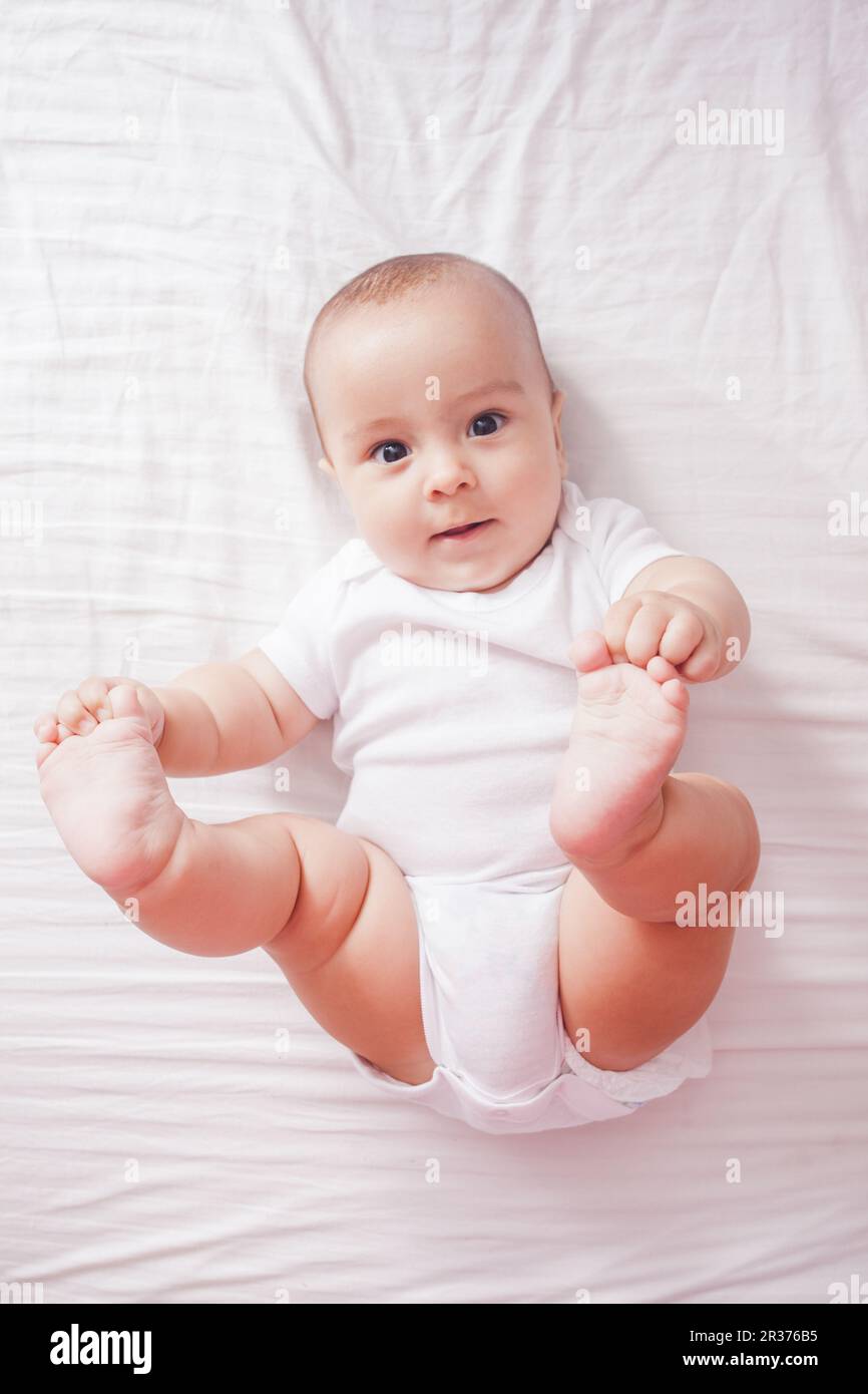 Cute happy little baby lying hi-res stock photography and images - Alamy