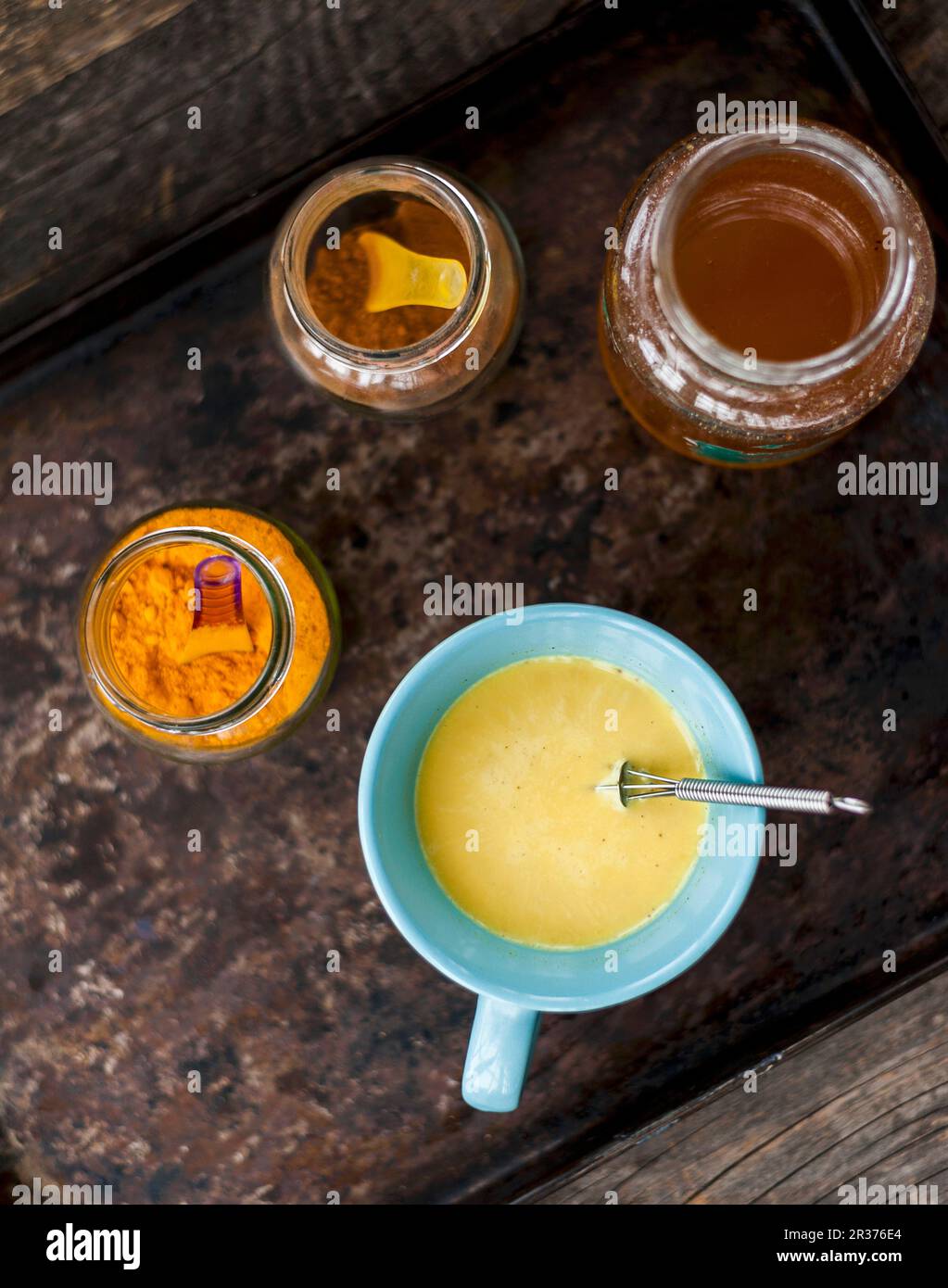 Golden milk (turmeric milk) with cinnamon and honey Stock Photo - Alamy