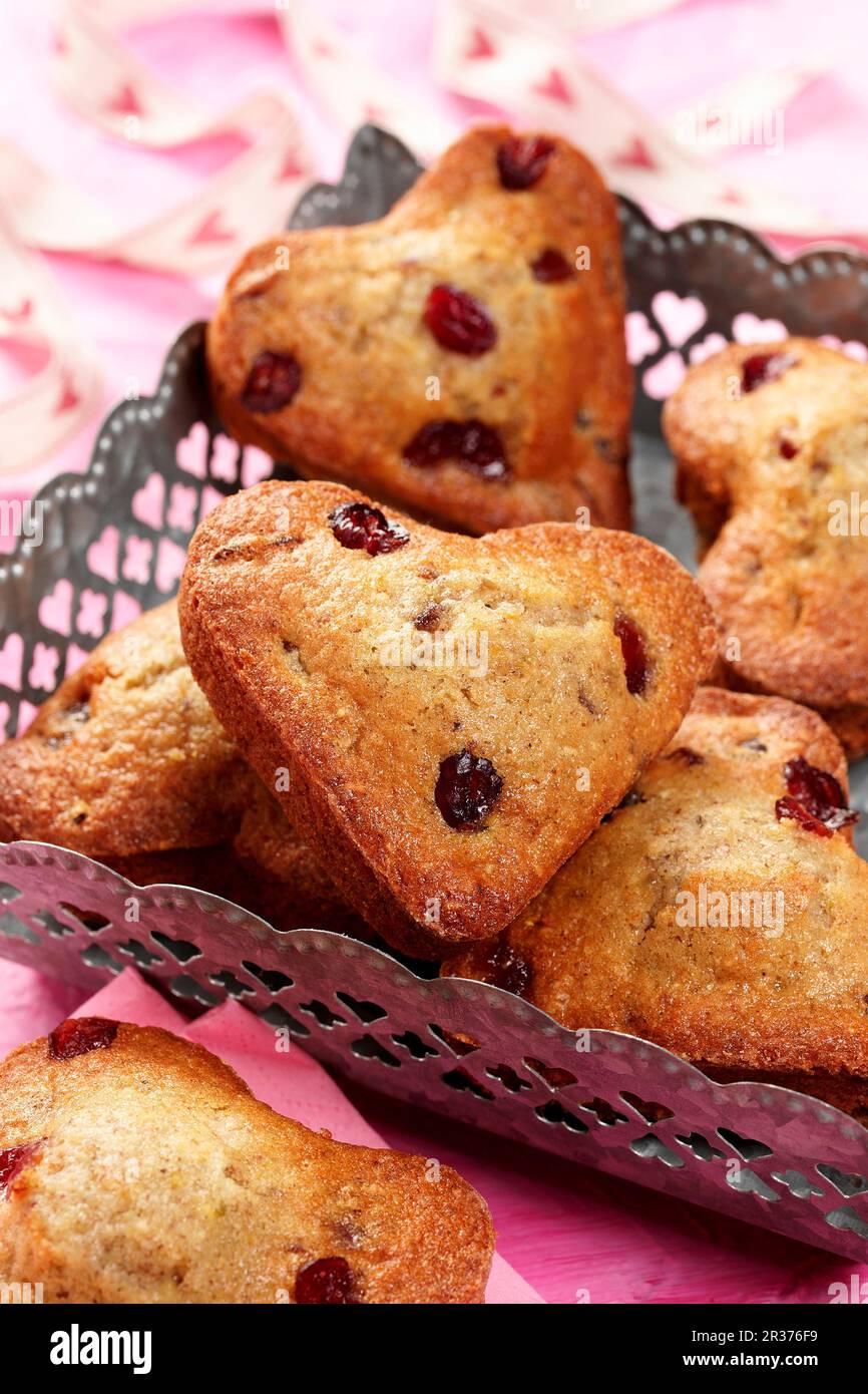 Heart shaped muffins in a metal basket on a pink background with pink ...