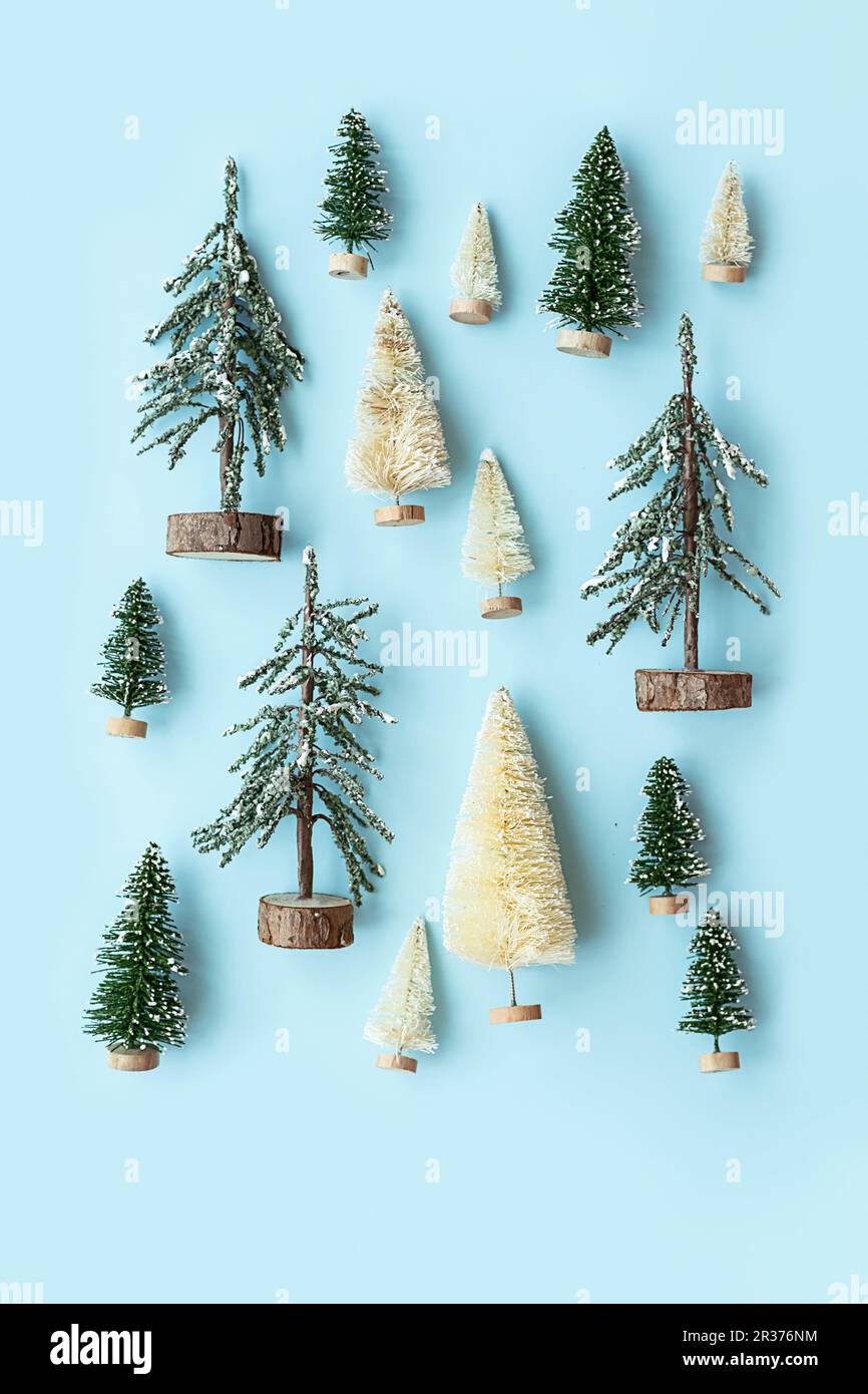 Artificial little Christmas trees layout. Winter holiday background ...