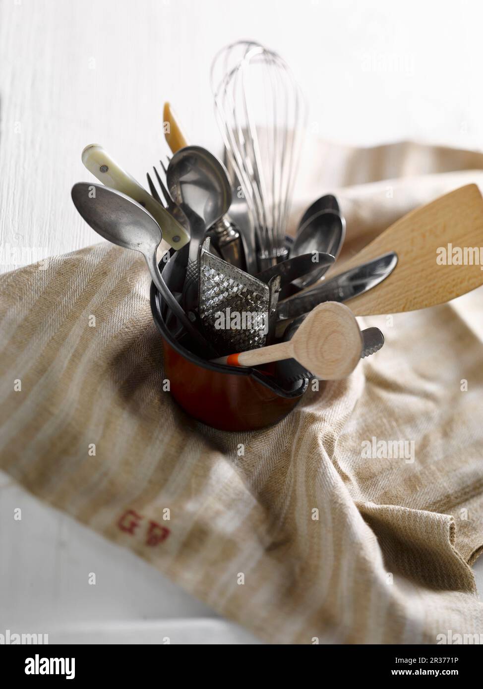 A small jug with old kitchen utensils Stock Photo - Alamy