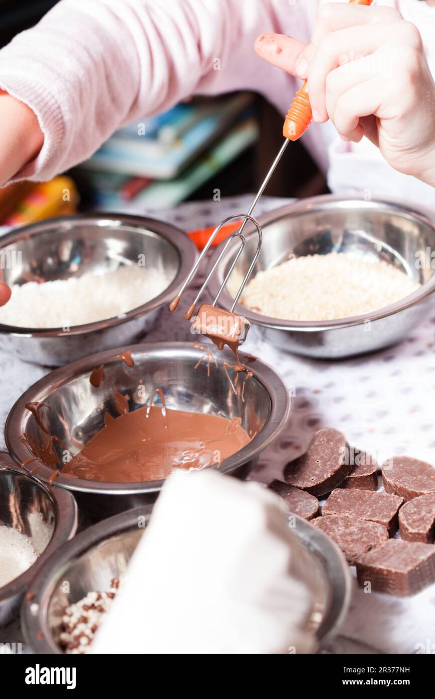 Little chef prepare chocolates Stock Photo - Alamy