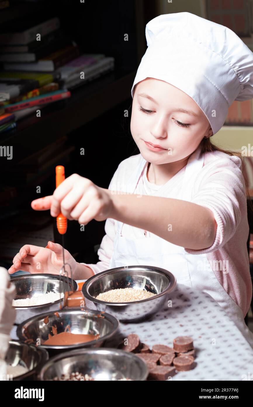 Little chef prepare chocolates Stock Photo - Alamy