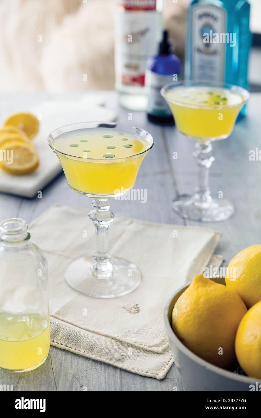 Ginger lime saffron gin cocktail with olive oil garnish Stock Photo - Alamy