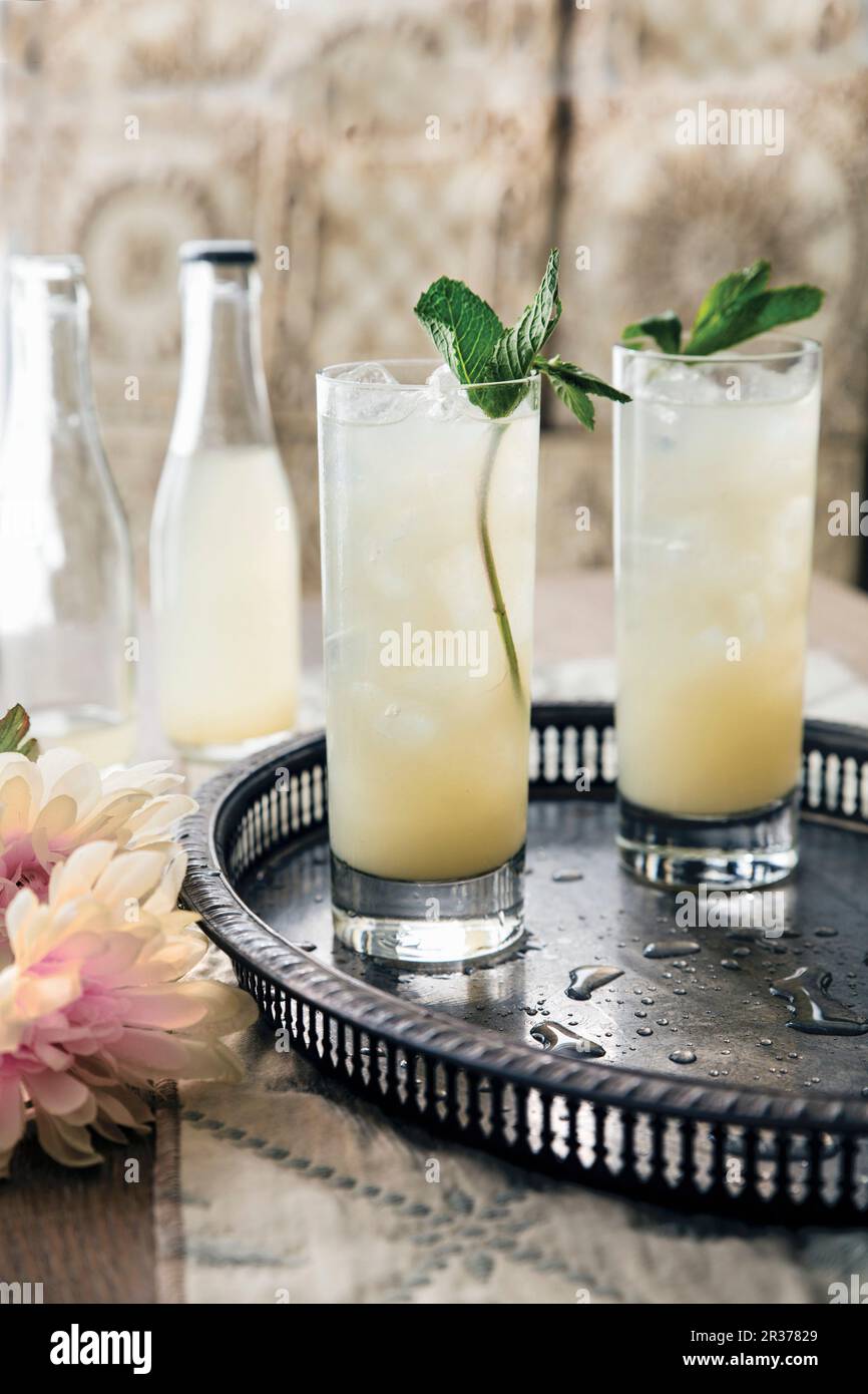 A gin and lavender cocktail with peach, elderflower cordial and a mint ...