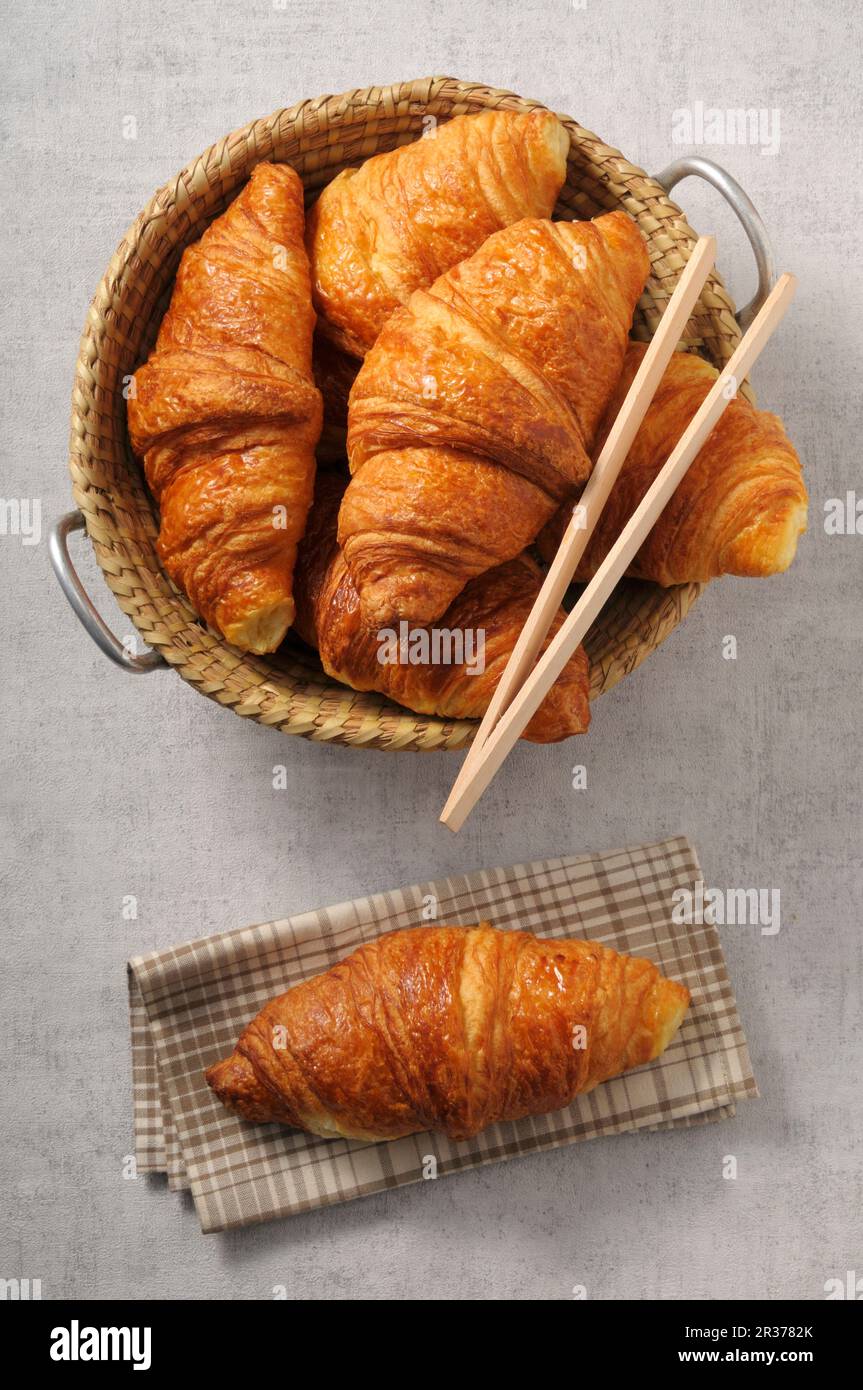 Fresh croissants in a basket Stock Photo - Alamy