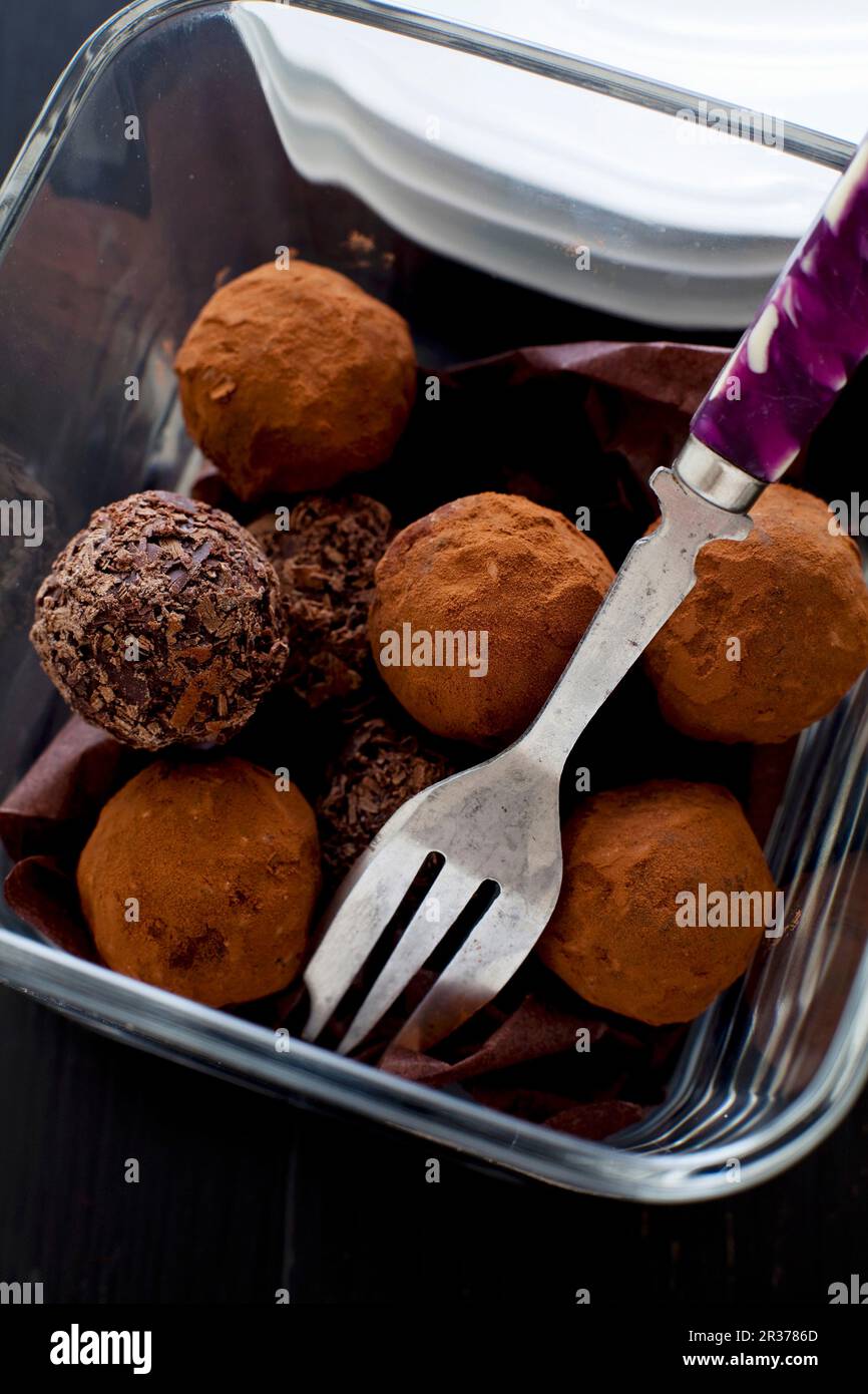 Chocolate truffles in a glass bowl with a fork Stock Photo - Alamy