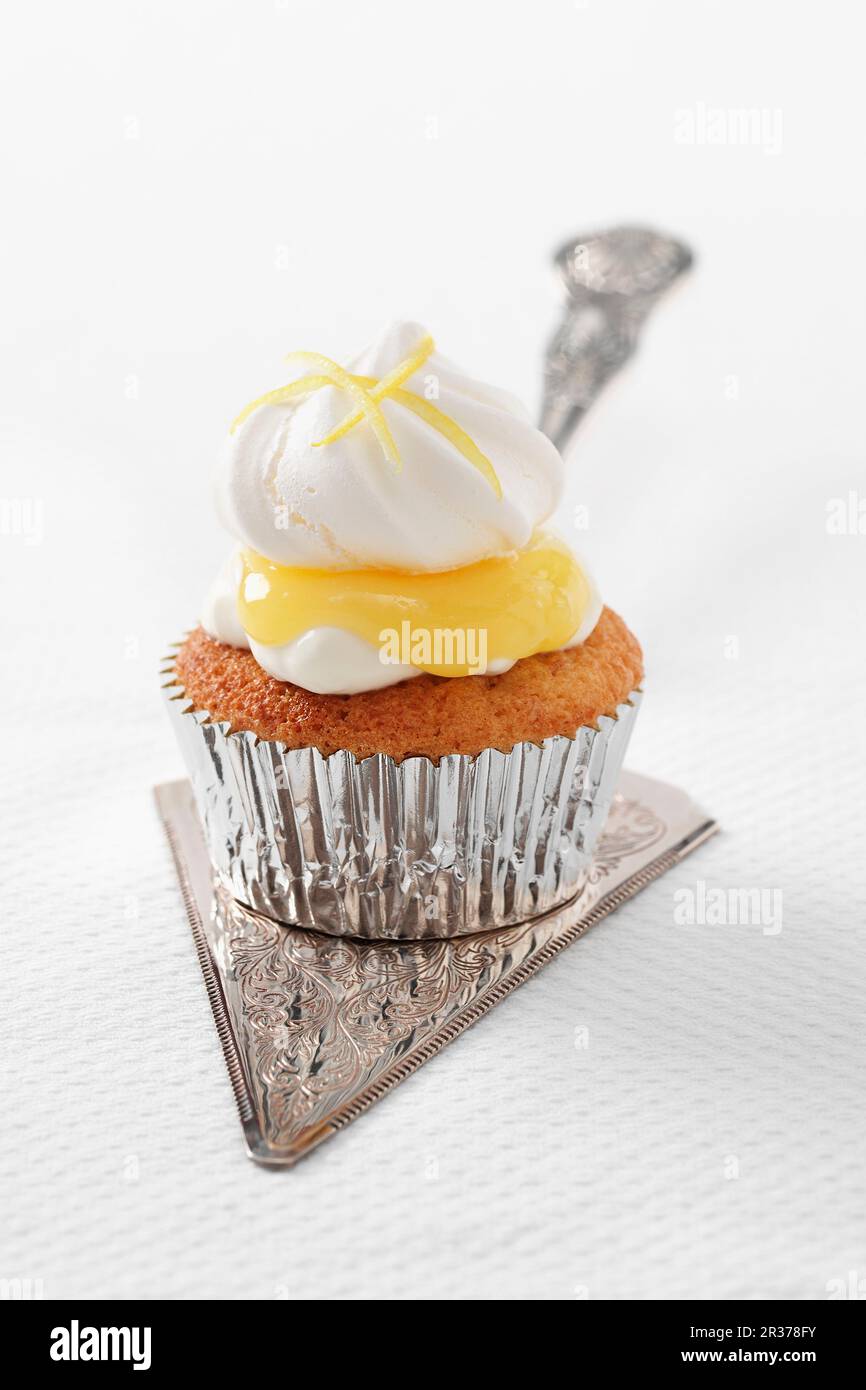 A single Lemon meringue cupcake with lemon curd in a silver case ...