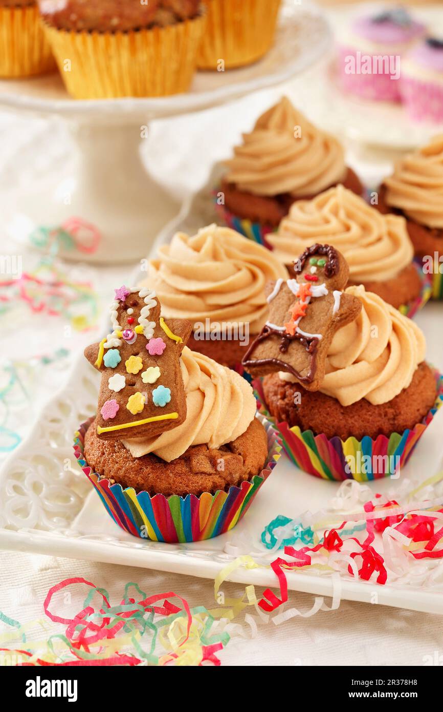Toffee cupcakes with gingerbread figures in a party setting Stock Photo ...