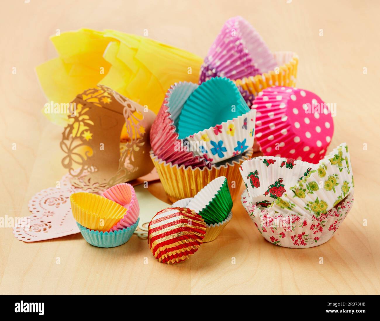 Various types and colours of cupcake and muffin cases on a wooden ...
