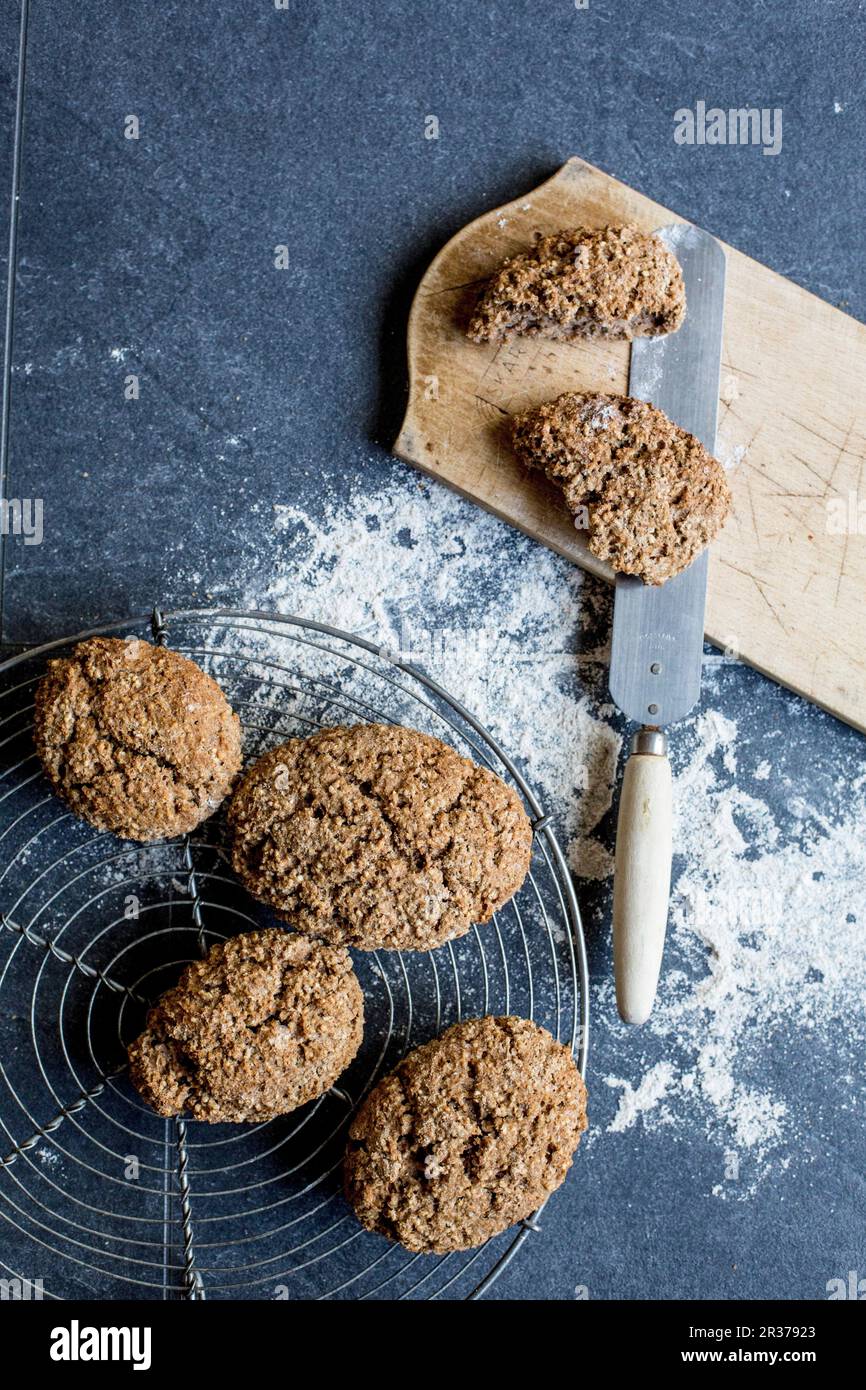 Rye bread rolls on a cooling rack and a chopping board Stock Photo - Alamy