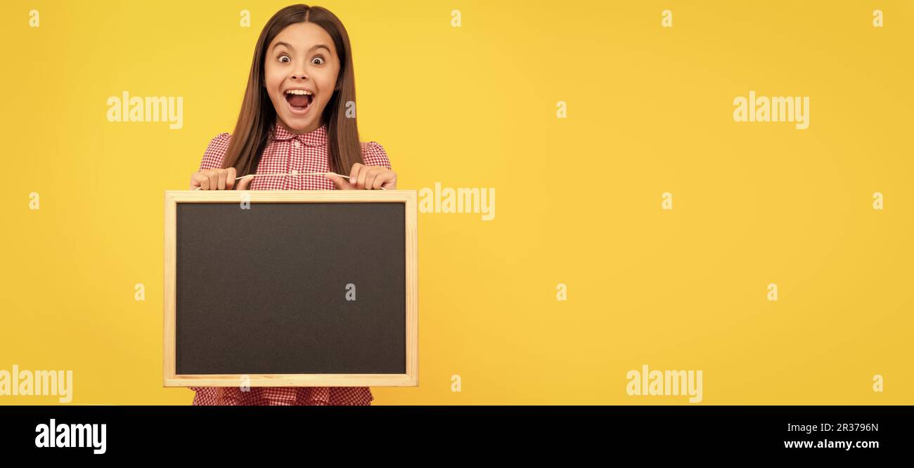 surprised child hold school blackboard for copy space, advertisement ...