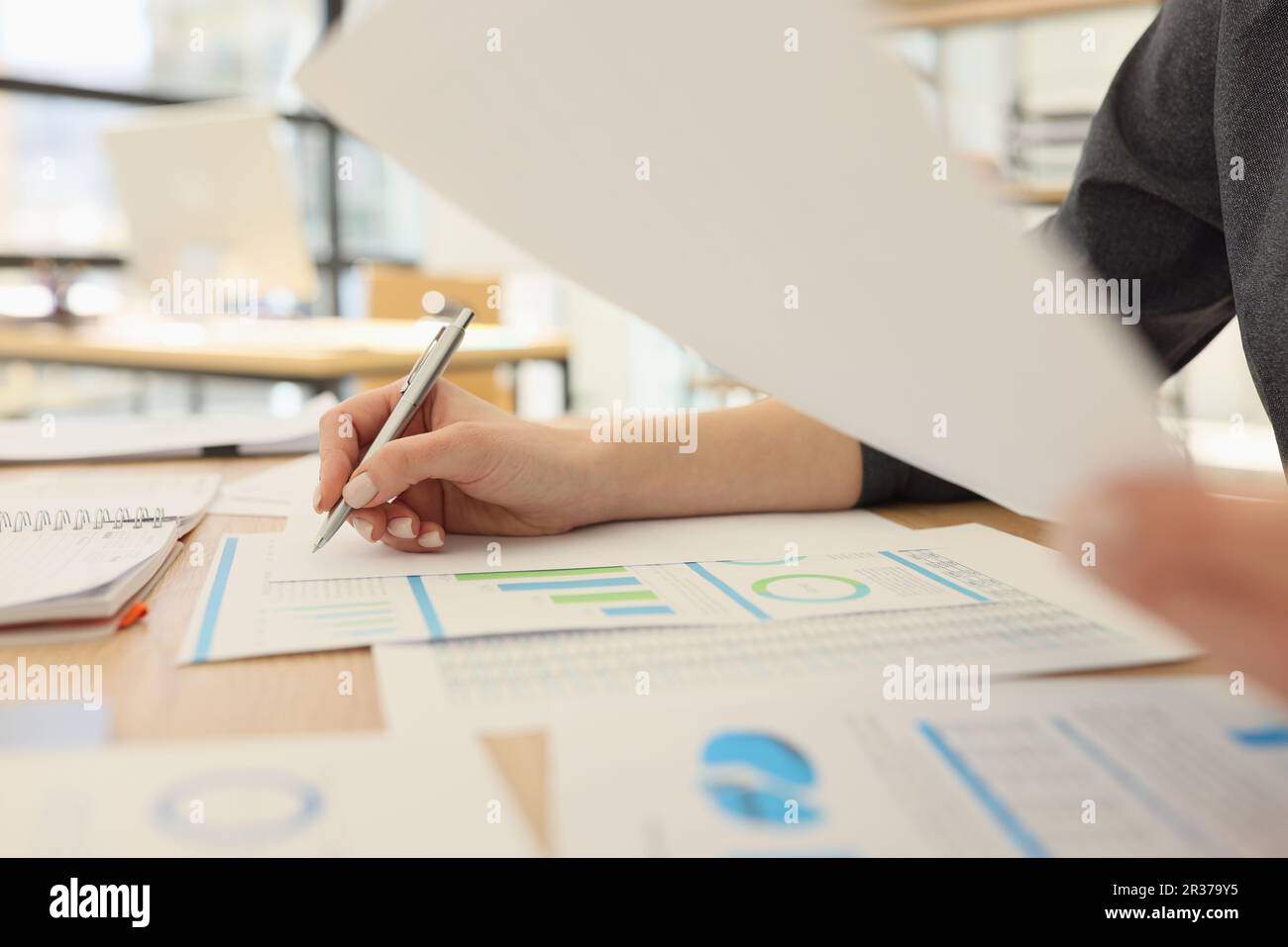 Secretary examines reports with diagrams and statistics Stock Photo - Alamy