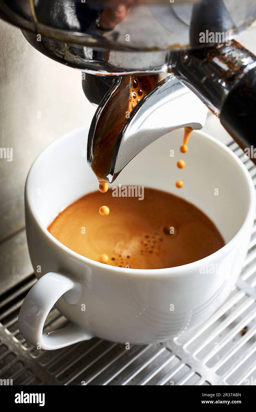 Coffee dripping from a coffee machine Stock Photo - Alamy