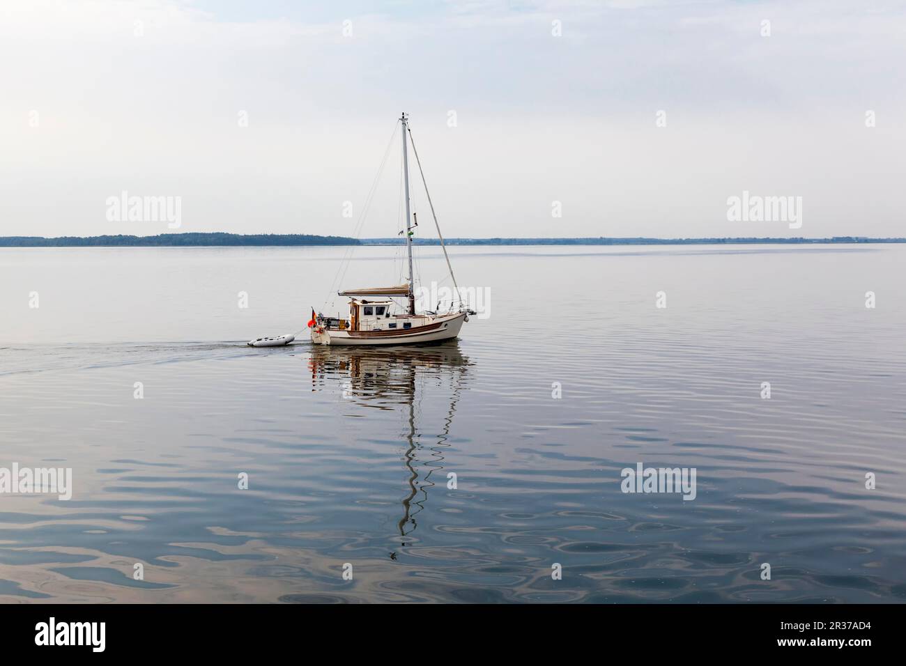 Small sailing boat with reflection on the Bodden Stock Photo - Alamy