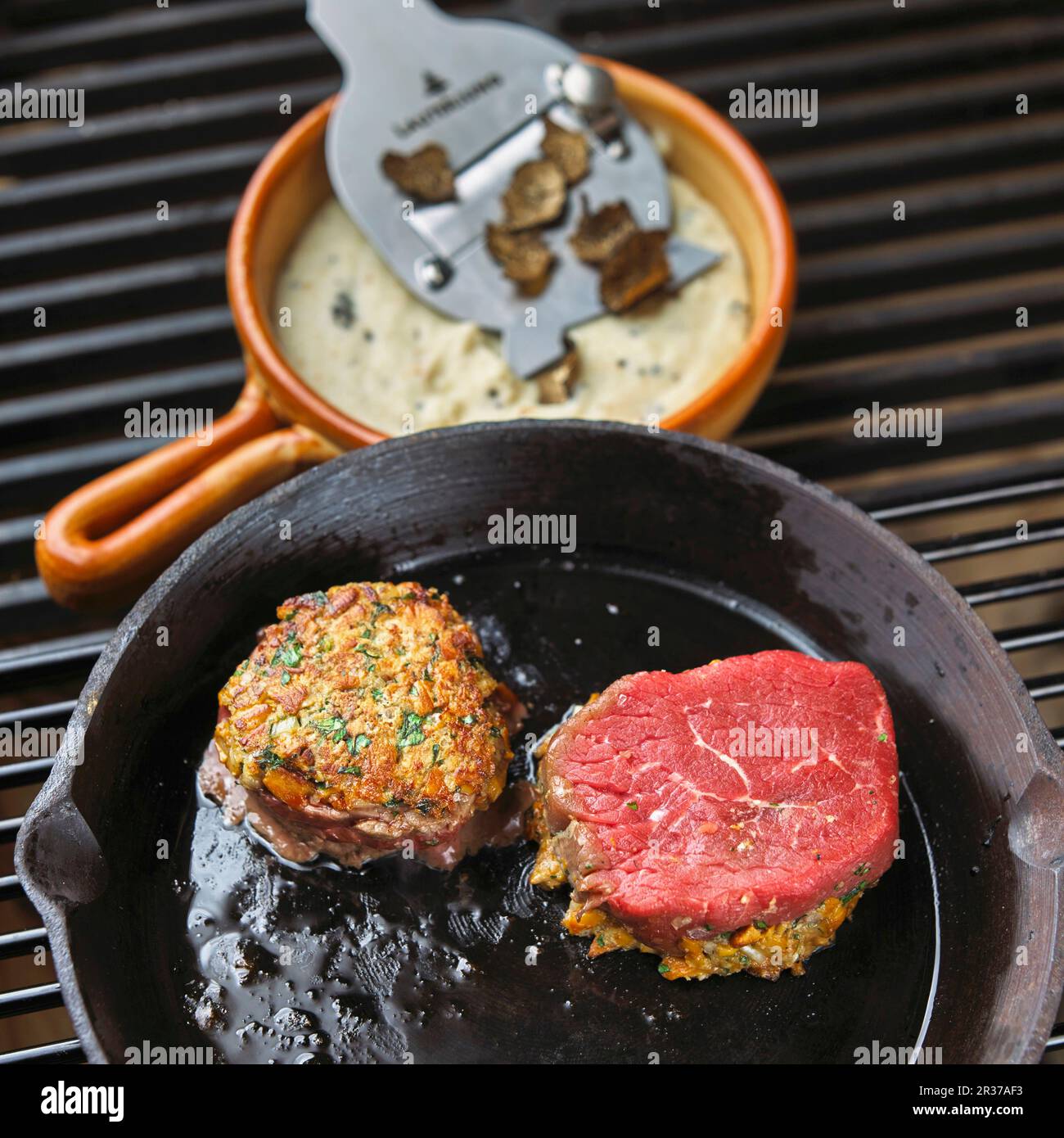 Beef steak with a cheese and herb crust and truffled polenta Stock ...