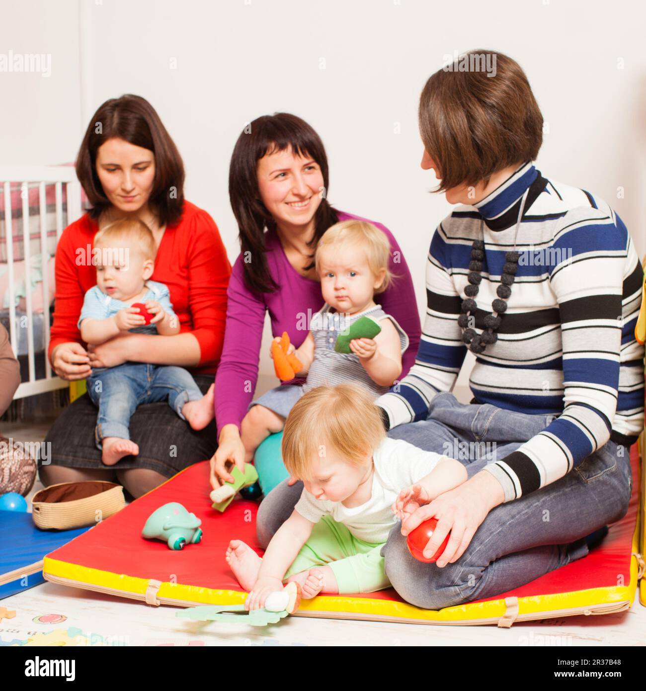 Group of mothers with their babies Stock Photo - Alamy