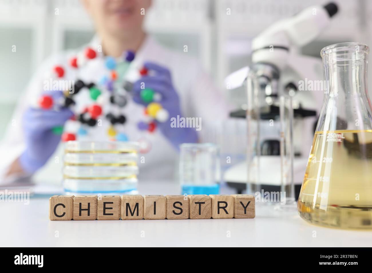 Word Chemistry against lab assistant showing molecule model Stock Photo ...