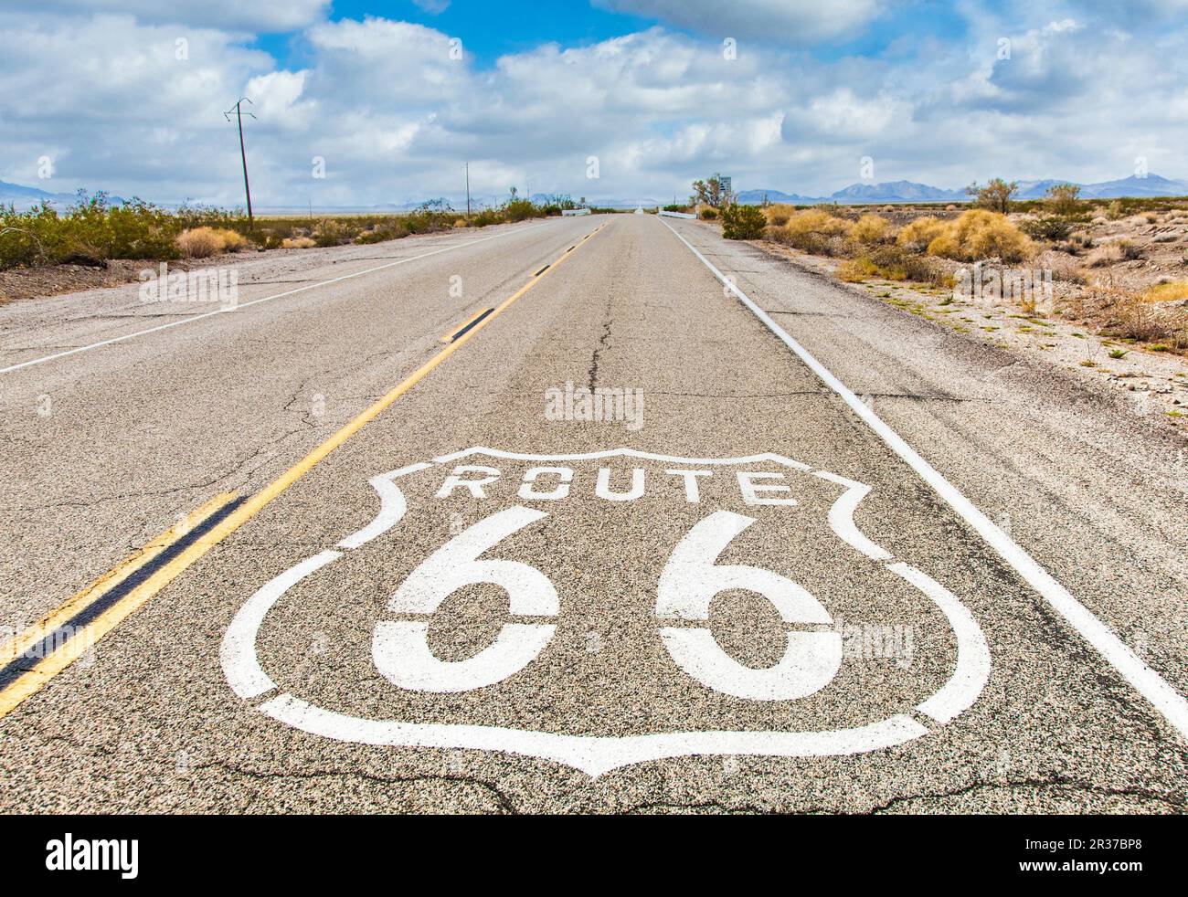 Route 66 road sign with blue sky background. Historic street with nobody. Classic concept for ...