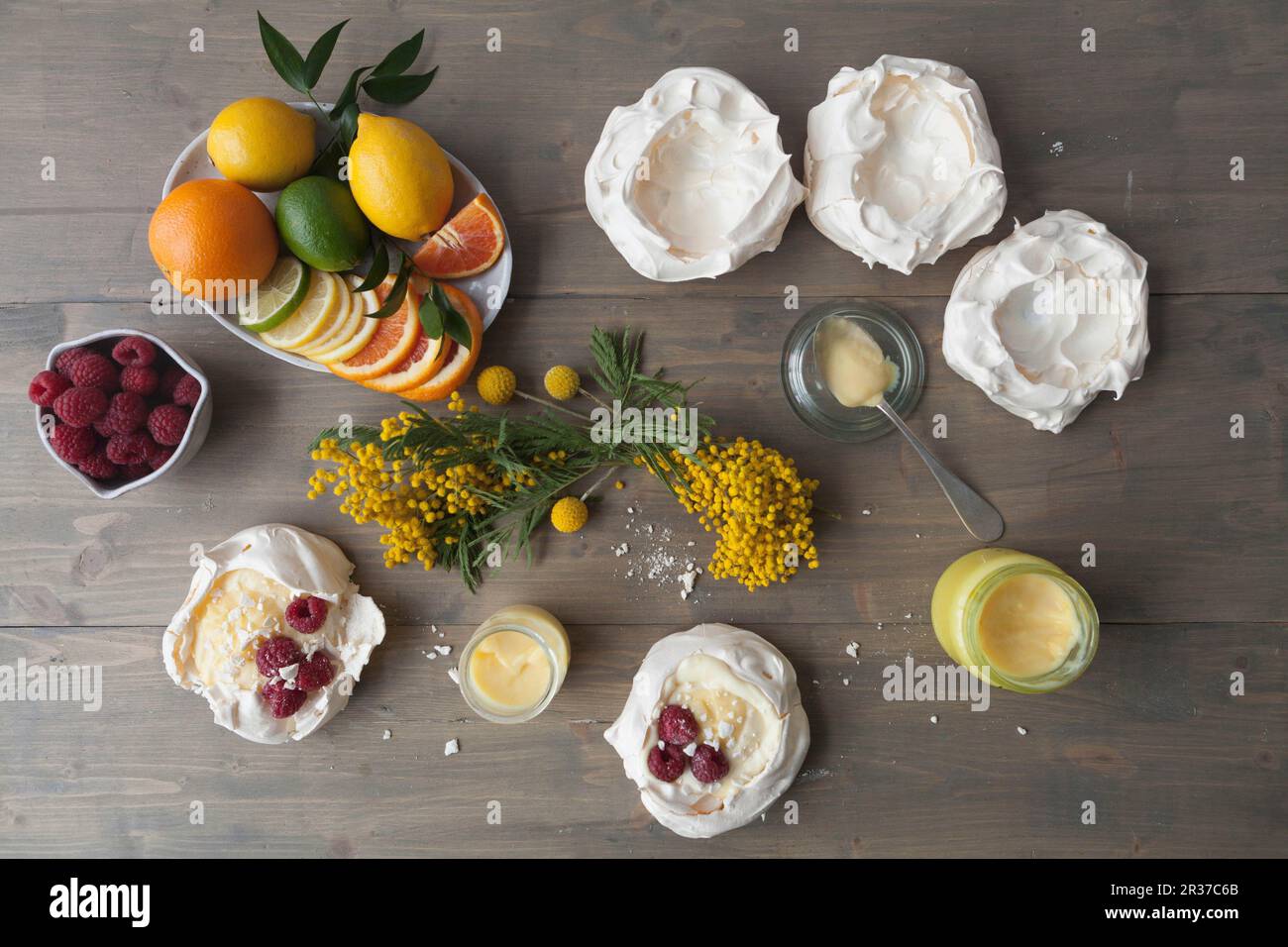 Meringue nests with lemon curd, citrus fruits and raspberries Stock ...