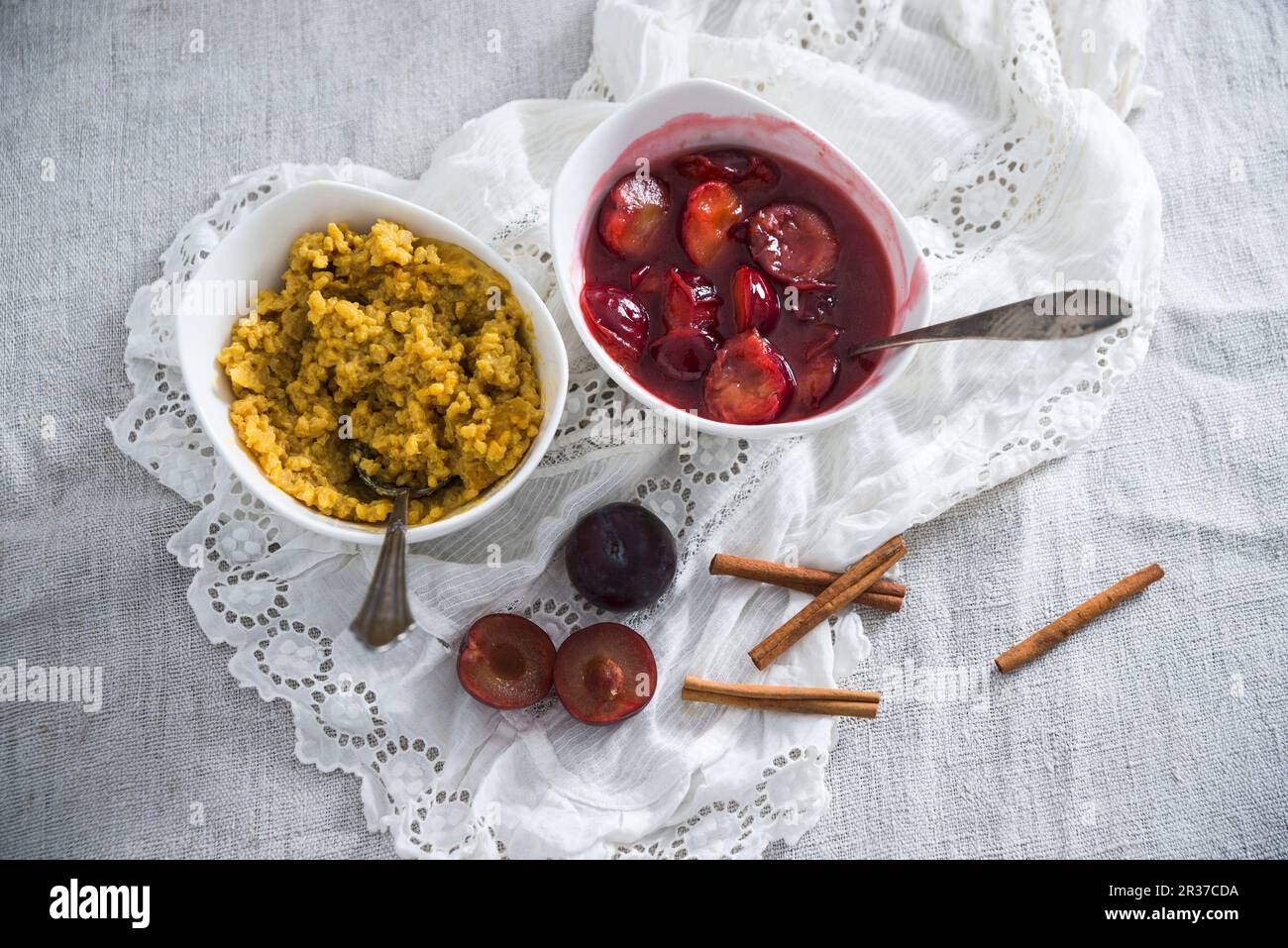 Turmeric milk rice with a plum compote (Vegan Stock Photo - Alamy
